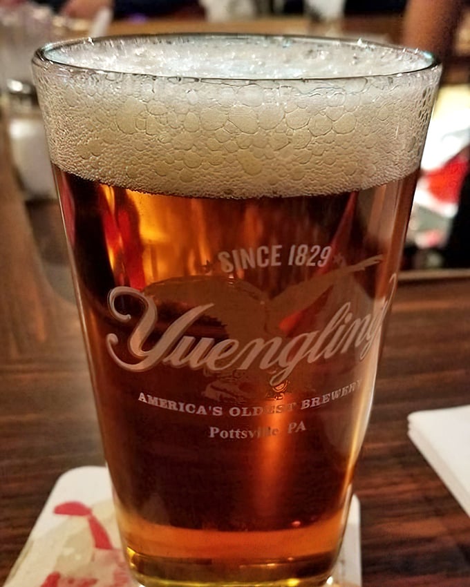 A perfectly poured Yuengling, America's oldest brewery represented in a glass that's sweating almost as much as you will be after finishing that sandwich.