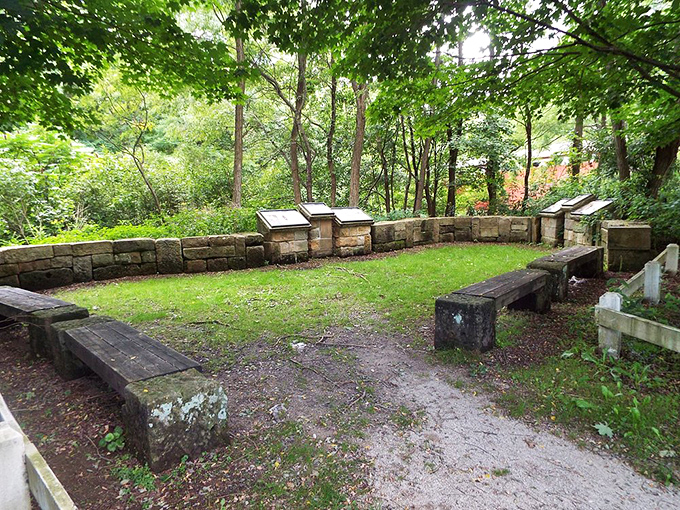 This thoughtful seating area invites contemplation. The stone wall has heard more family picnics and philosophical discussions than any therapist's couch.