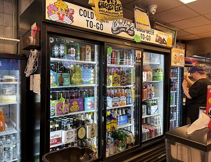The beverage cooler—a colorful oasis of liquid refreshment options, because washing down greatness requires proper hydration choices.