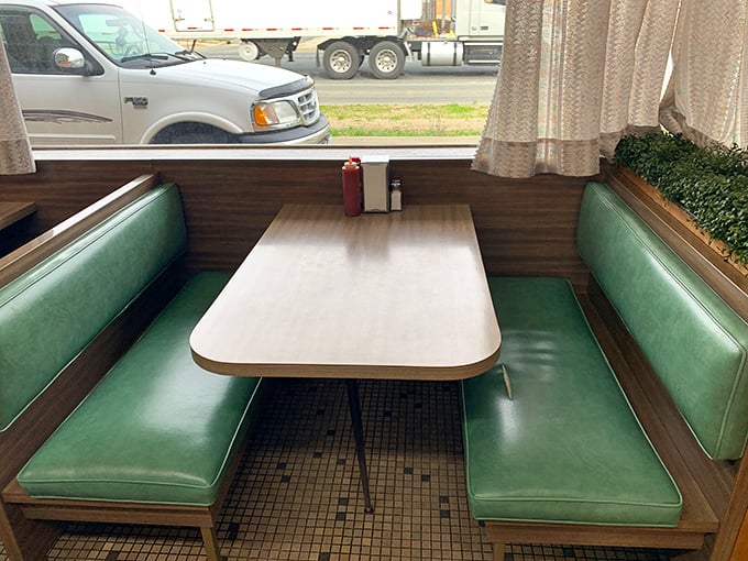 The green vinyl booth—where countless first dates, business deals, and "I shouldn't have a third burger but watch me" decisions happen.