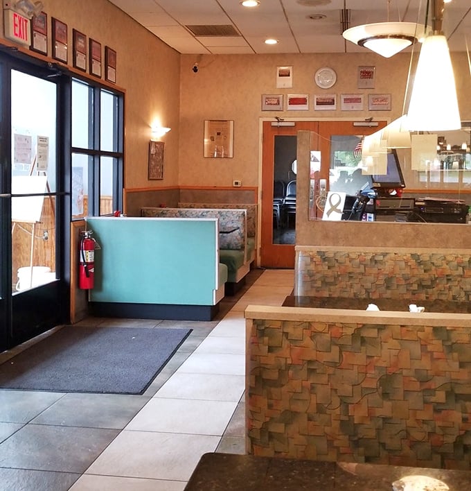 The entryway booths—prime real estate for people-watching while your toast achieves the perfect butter-to-jelly ratio.