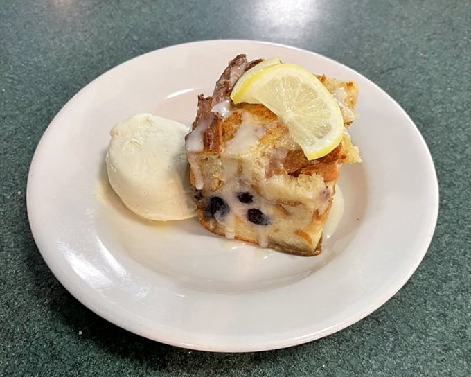 Bread pudding that's having an identity crisis with that lemon slice and ice cream – dessert that's both homey and sophisticated.
