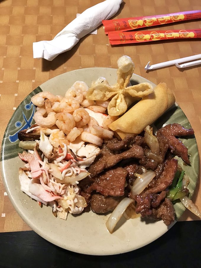 The ultimate buffet plate: a personal masterpiece featuring beef, shrimp, crab, and a crunchy egg roll. Michelangelo couldn't have sculpted better.