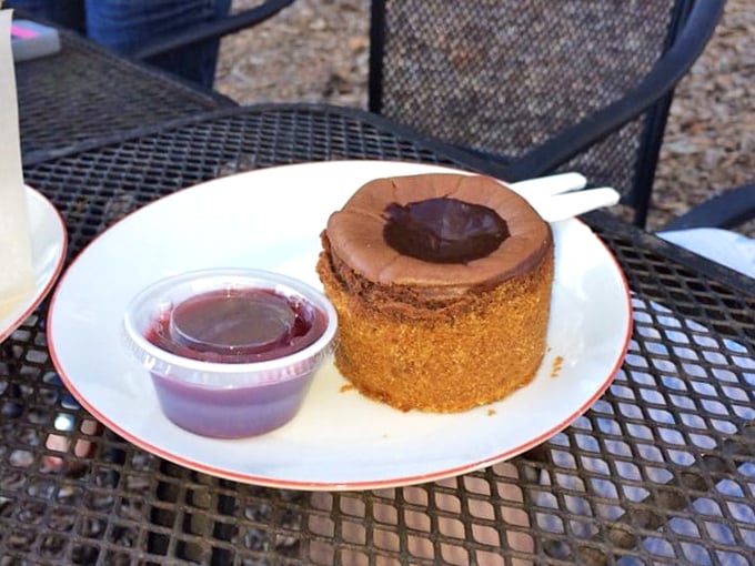This chocolate creation isn't just dessert—it's therapy without the hourly rate. The little cup of berry sauce adds that perfect sweet-tart counterpoint.