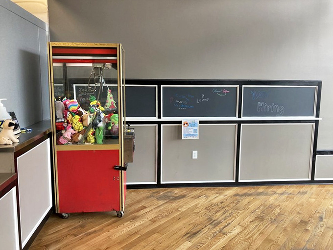 A classic claw machine adds nostalgic charm, reminding diners that some pleasures never go out of style completely.