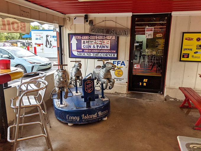Not just any kiddie ride—a carousel of miniature horses that's probably carried generations of tiny diners. Quarter-powered nostalgia at its finest. 