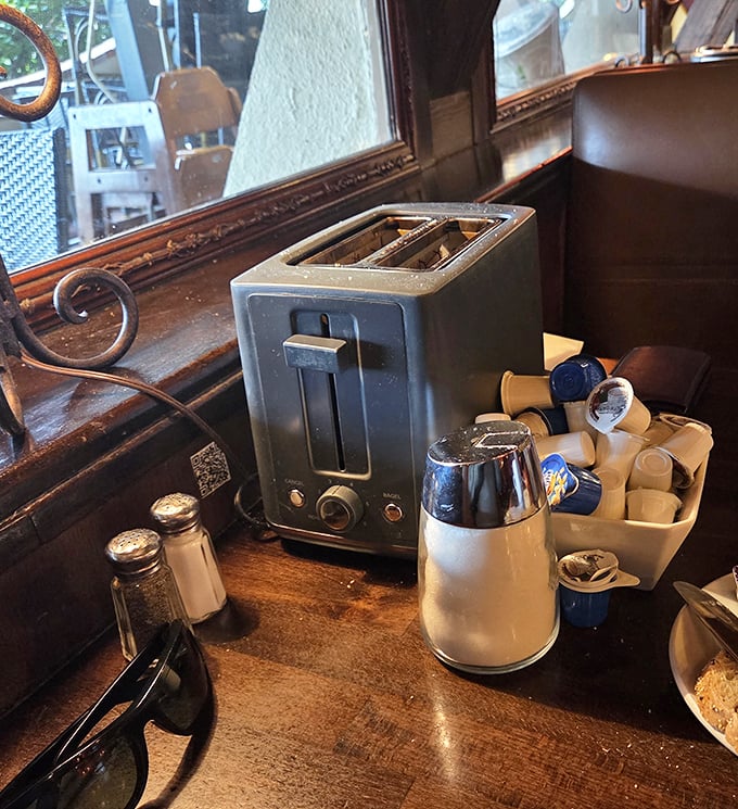 The humble altar of diner condiments—salt, pepper, creamer, and sugar. Simple tools for customizing your breakfast masterpiece.