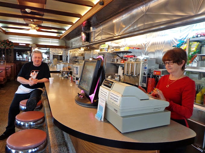 The heart of any great diner—where regulars perch and servers orchestrate the morning symphony of coffee and conversation.