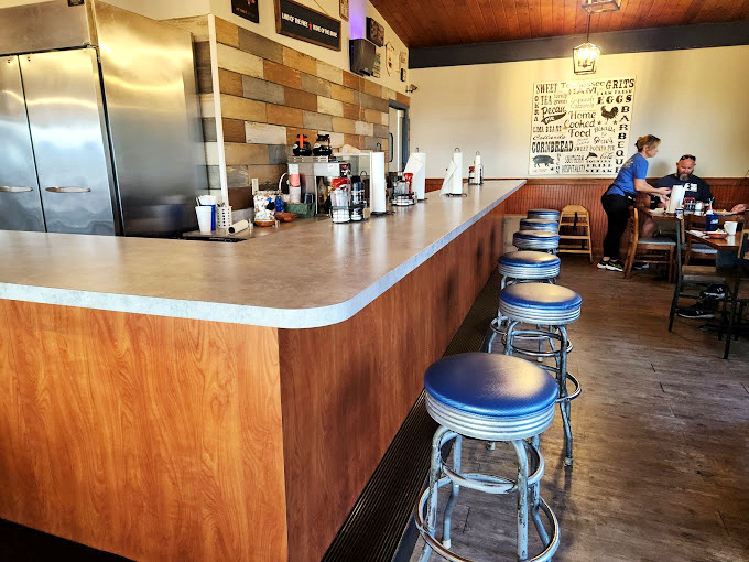 Classic diner counter seating where regulars have worn their loyalty into the very stools, one breakfast at a time.