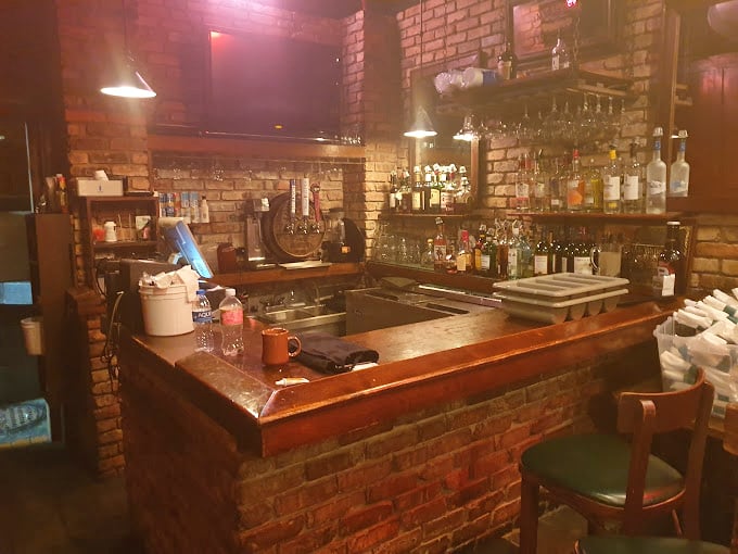 A bar built from honest brick and wood—where bartenders likely know regulars by name and drink preference without asking.