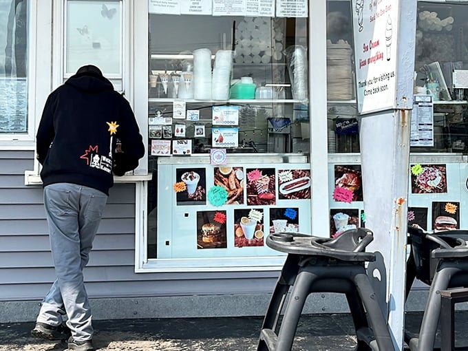 The sacred transaction at the ordering window—where summer cravings meet their match and dietary resolutions go to die.