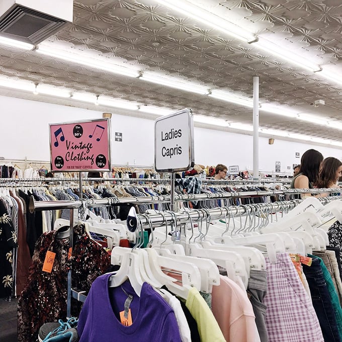 The distinctive ceiling tiles watch over shoppers hunting for deals—under these lights, the thrill of the find is written on every face.