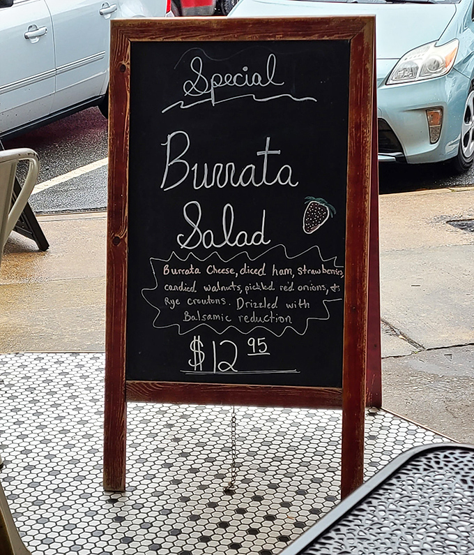 Chalkboard specials—like this tempting burrata salad—change with the seasons, showcasing the kitchen's creativity and commitment to fresh ingredients.