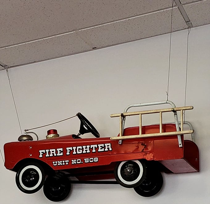 The vintage fire truck dangling from the ceiling—proof that whimsy is always on the menu at Dolly's Diner.