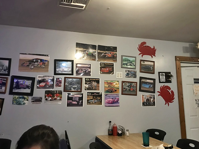 The wall of racing photos and crab decorations tells you everything – this is a place that celebrates local passions alongside seafood traditions.