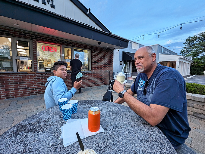 Multi-generational ice cream enjoyment—proof that the best family traditions involve dairy fat and sprinkles. Some lessons don't need words.