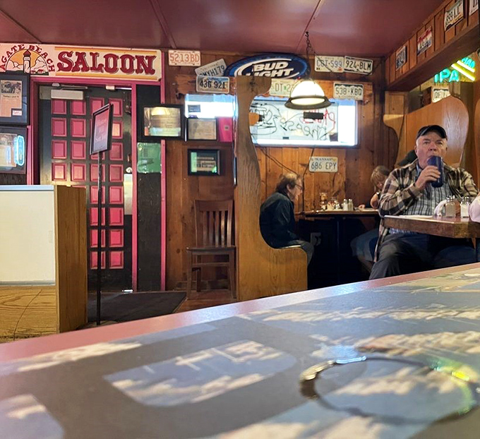 The saloon area offers the perfect blend of privacy and community—where strangers become friends over shared appetizers.