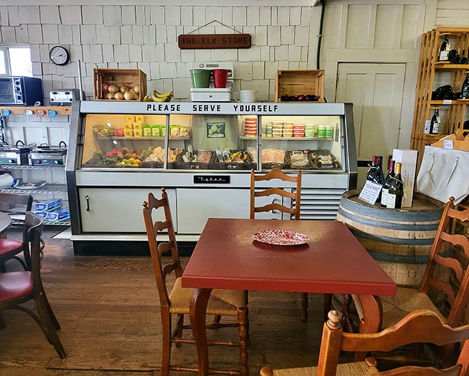The "Please Serve Yourself" sign above the deli case—an invitation to culinary adventure in a room where time slows down.