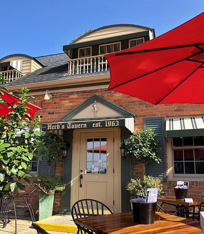 The entrance to Herb's Tavern isn't just a door—it's a portal to comfort food nirvana, framed by brick and greenery that whispers, "Come on in."