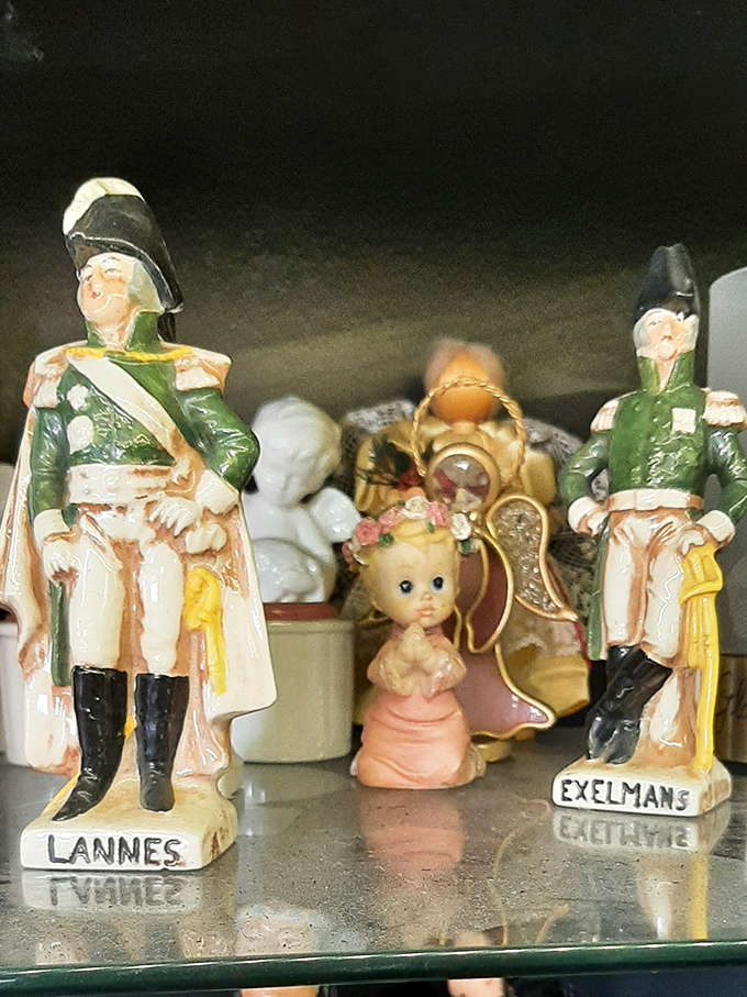 These vintage figurines tell stories from another era. Military miniatures stand at attention beside kewpie dolls in an unlikely antique alliance.