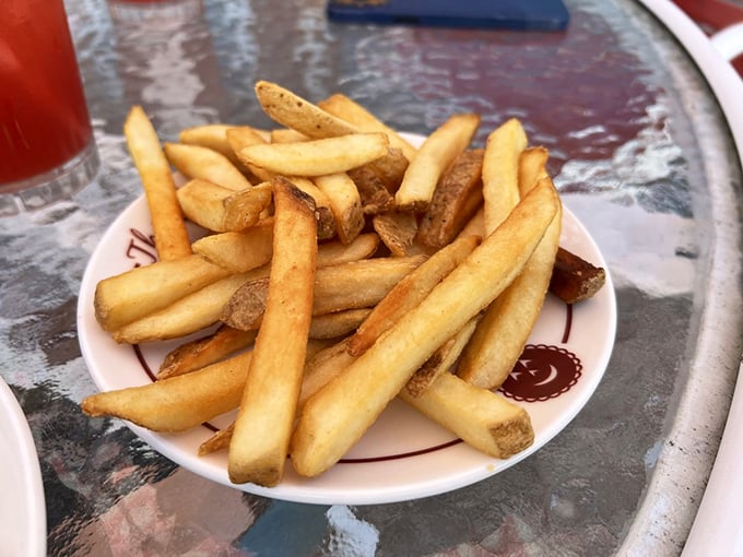 French fries done right – golden, crispy, and served on plates with smiling cherries. Even the potatoes here know they're in cherry country.