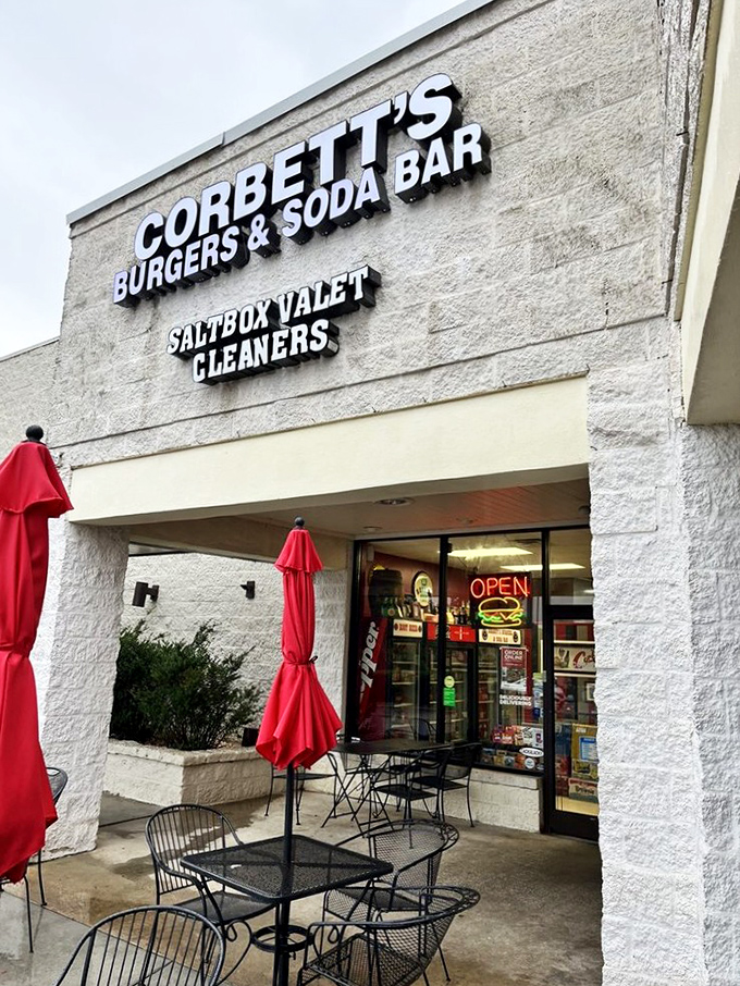 The storefront might be modest, but those red umbrellas promise shade for serious eating business.