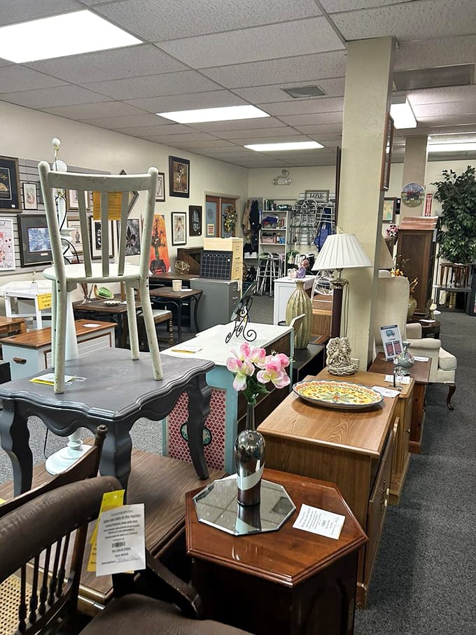 Furniture arranged like a home décor fever dream—mismatched tables and chairs that somehow make perfect sense in this thrifter's paradise.