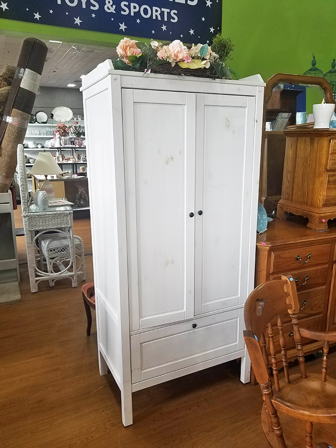This white armoire isn't just storage—it's the wardrobe that might actually lead to Narnia, or at least to better-organized seasonal clothing.