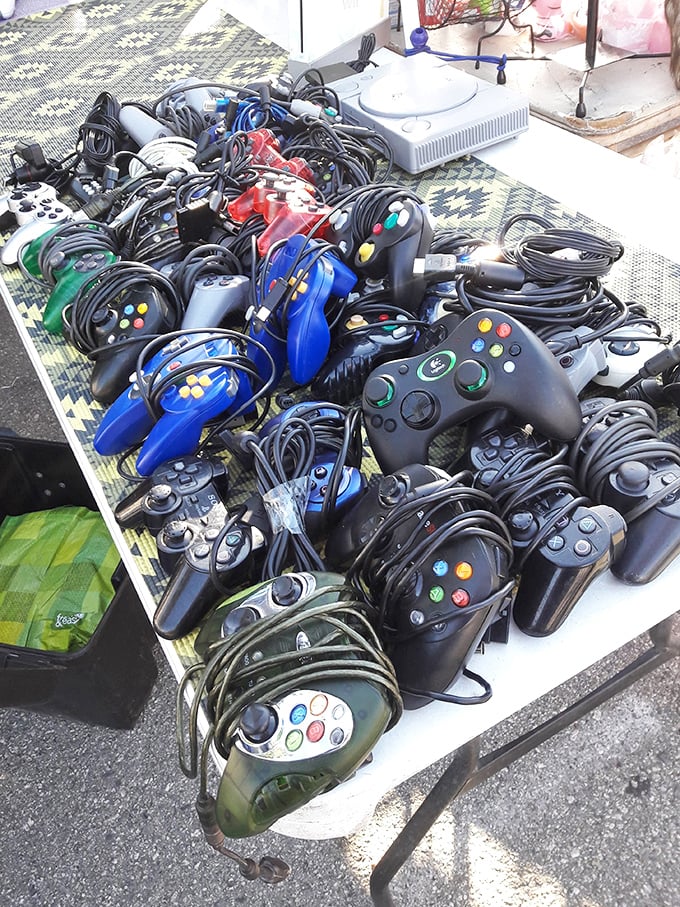 Gaming nostalgia tangles across the table—a nest of controllers from bygone console eras waiting to reconnect players with their digital youth.