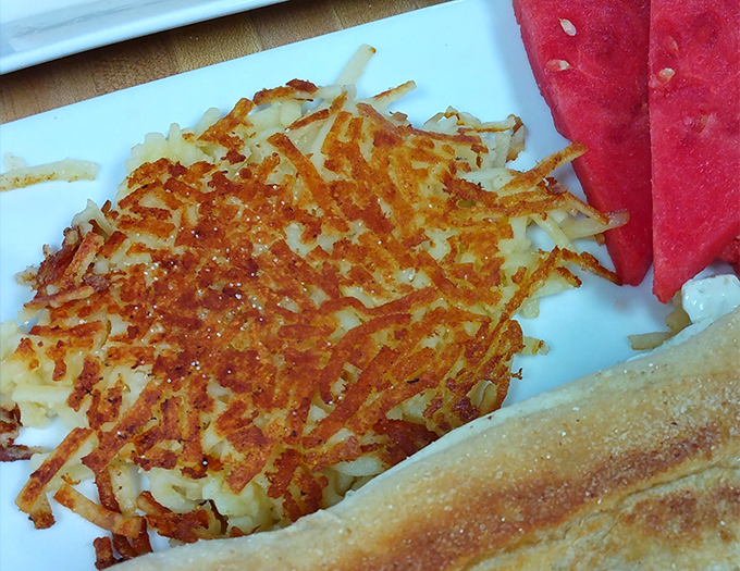These hash browns deserve their own fan club – golden, crispy, and perfectly seasoned, they're the unsung heroes of the breakfast plate.