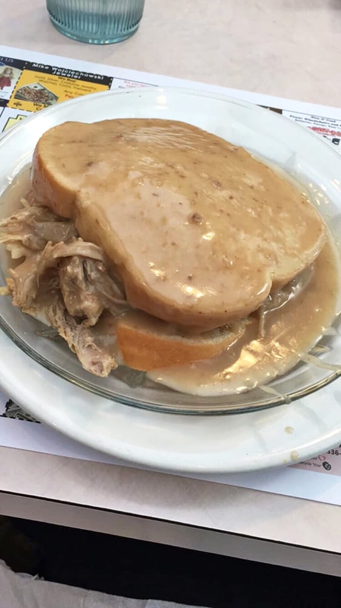 Hot turkey sandwich swimming in gravy—Thanksgiving on a plate, no holiday required. This is what comfort food aspires to be.