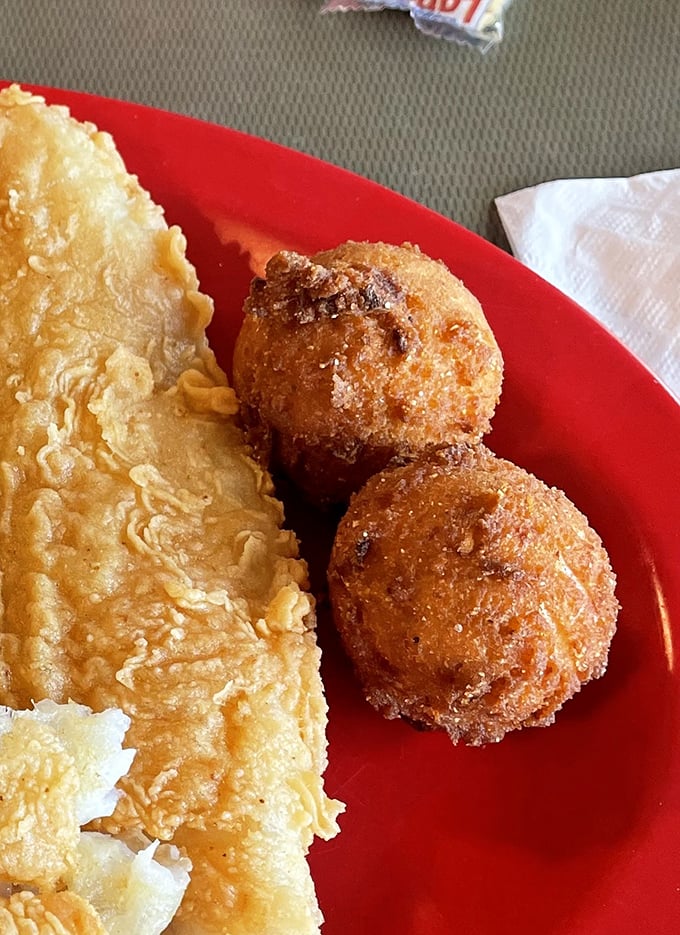 Golden hush puppies that crunch like a perfect autumn leaf – crispy exterior giving way to a tender cornmeal interior that whispers, "Welcome to the South."