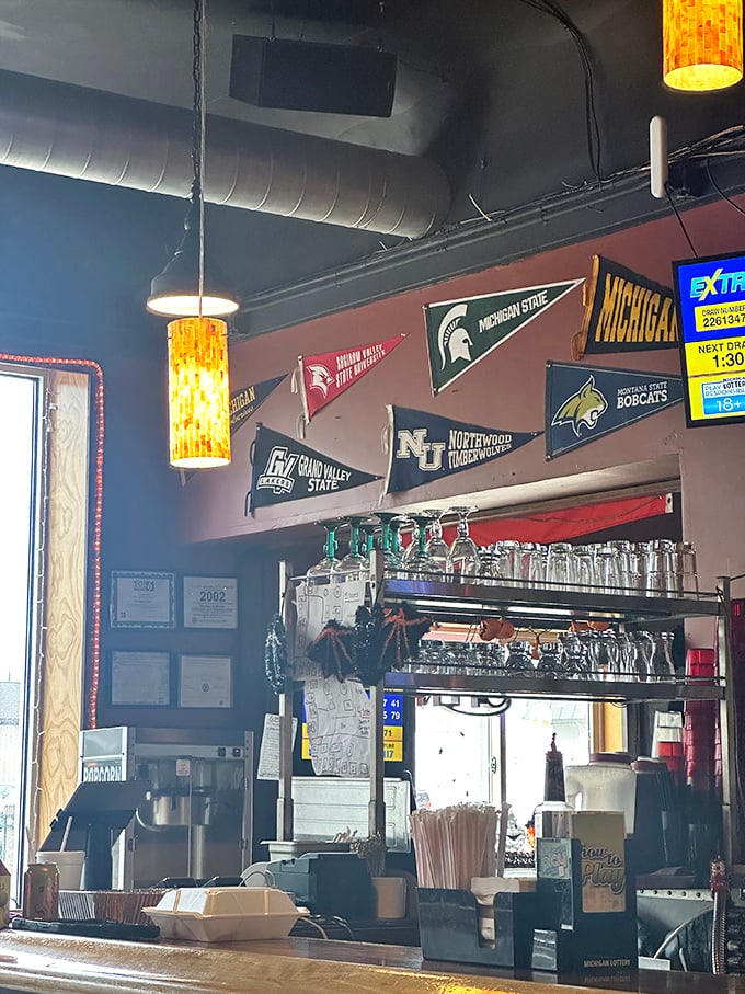 College pennants and memorabilia create a shrine to Michigan sports pride. Here, team rivalries are temporarily forgotten when the food arrives.