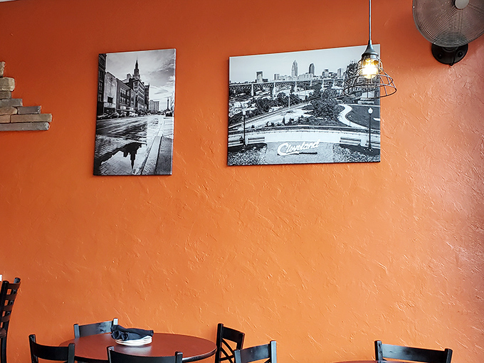 Cleveland pride on vibrant orange walls—black and white cityscapes remind you that great food and hometown love go hand in hand.