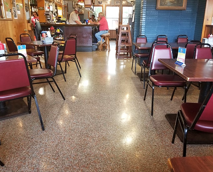 The terrazzo floors and burgundy chairs aren't trying to impress anyone—they're just setting the stage for the real stars from the kitchen.