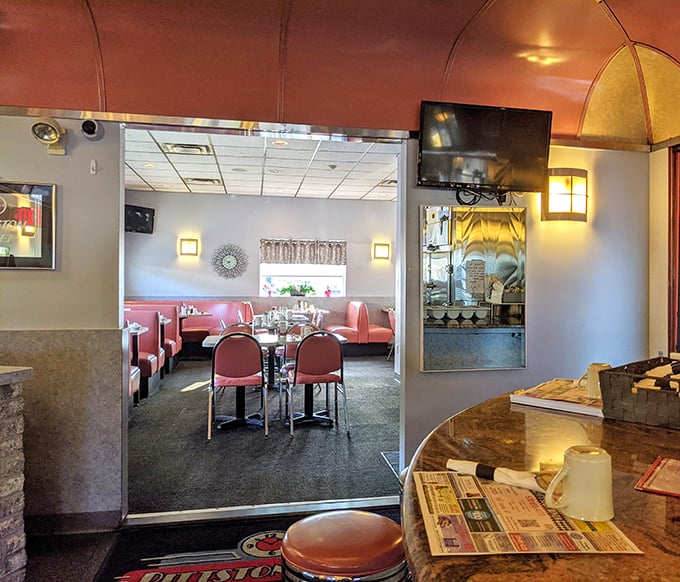 Pink booths and chrome tables—not just furniture, but time machines to when conversations happened face-to-face and phones were just for calling.