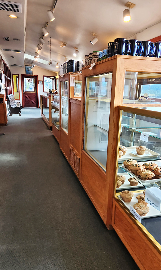 The pastry case corridor—where willpower goes to die and "I'll just have one bite" becomes a laughable concept.