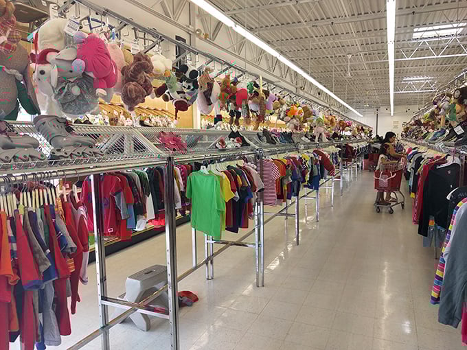The children's section, where stuffed animals keep watch over tiny clothes. Kids outgrow everything so fast, why pay full price?