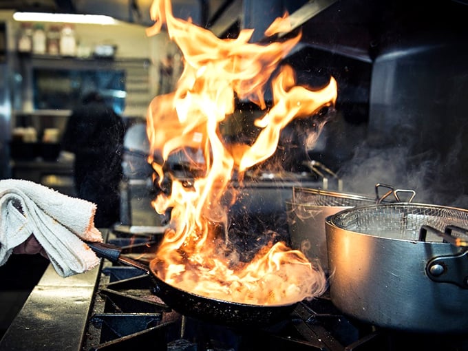Fire-kissed perfection in progress. In the kitchen, flames leap and dance—nature's way of telling you this meal is going to be memorable.