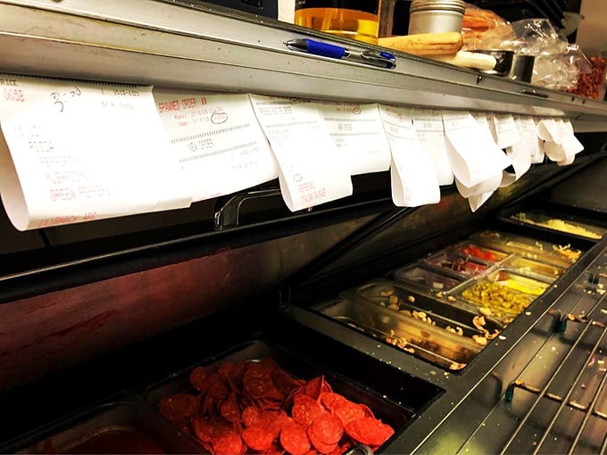 The pizza assembly line—where toppings wait like actors in the wings before their starring role on your perfect pie.