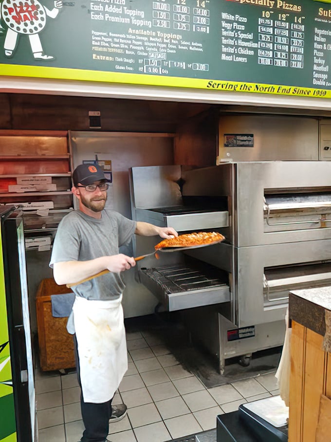 The pizza paddle in action – that moment of anticipation when your pie is about to meet its destiny in the oven.