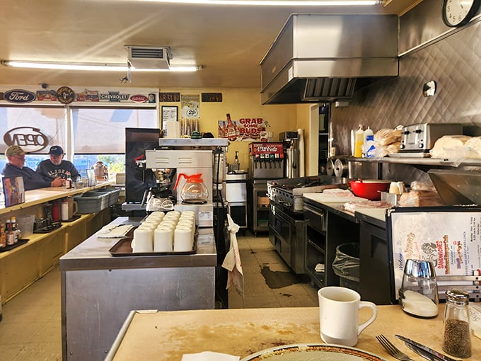 The kitchen—command central for comfort food operations. No molecular gastronomy happening here, just the beautiful choreography of short-order cooking.