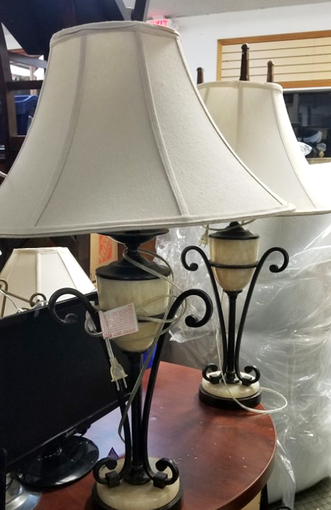 Elegant lamps that have illuminated countless late-night reads and romantic dinners, their wrought iron bases curling like question marks about their next chapter.