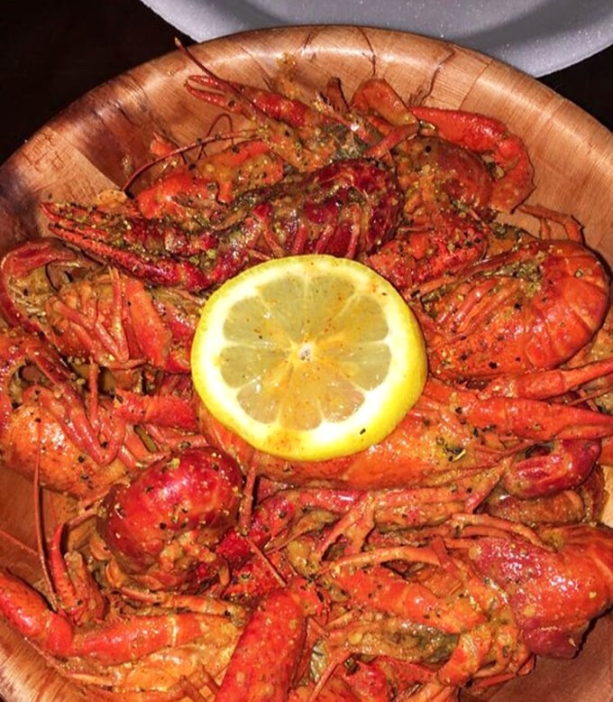 These crawfish, arranged like a spicy sunburst around a lemon moon, aren't just food—they're edible art with attitude.