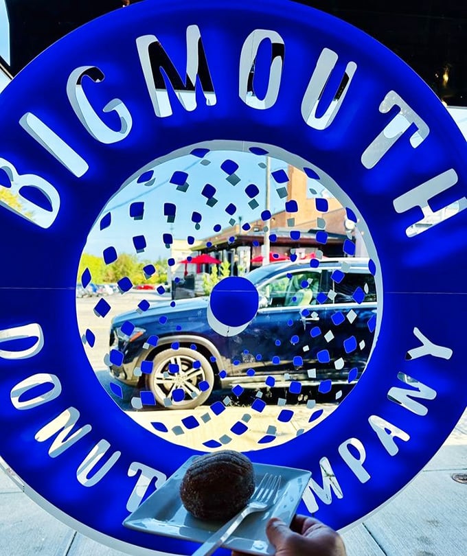 The blue neon logo glows like a portal to another dimension—one where calories don't count and joy is measured in sprinkles.