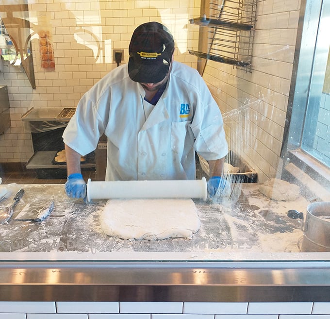 Watching the biscuit master at work is like seeing a sculptor with flour—rolling pin in hand, creating edible art that will disappear minutes later.