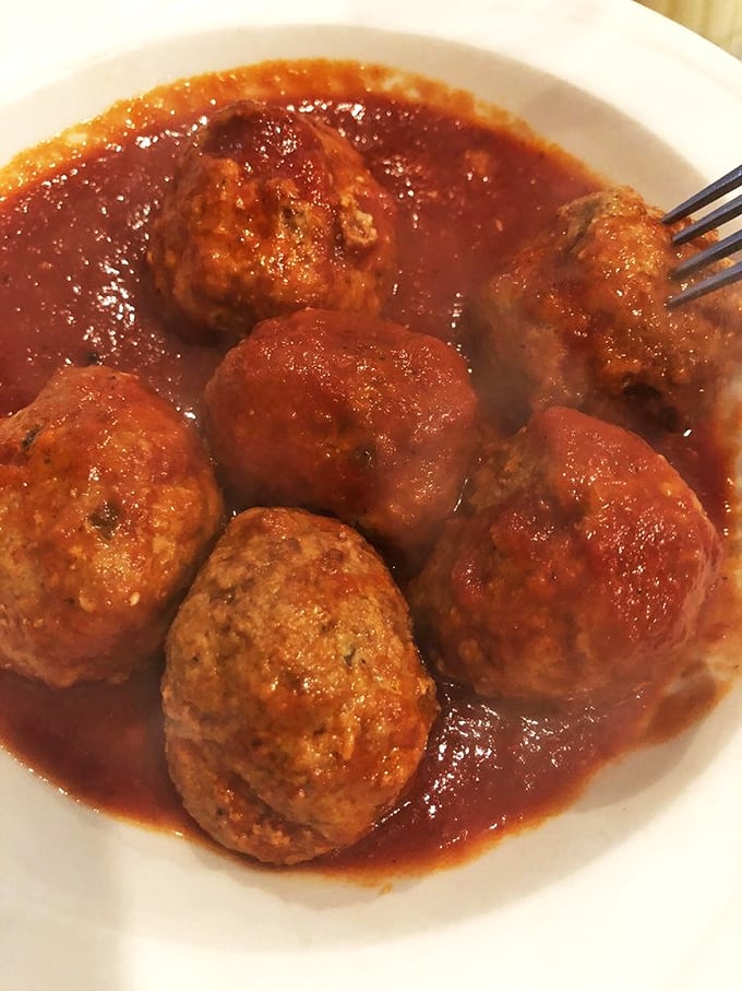 Meatballs that don't mess around—substantial, savory spheres swimming in a sea of rich tomato sauce, waiting to fulfill their pasta-accompanying destiny.