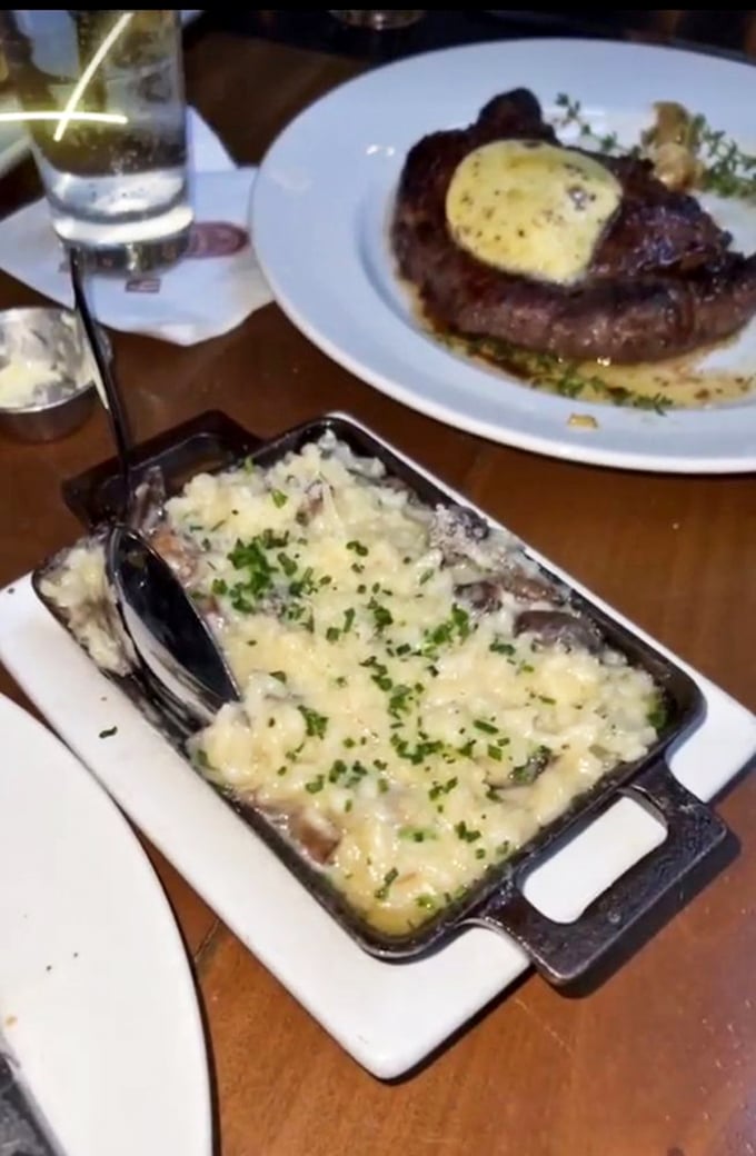 A steak topped with compound butter melting into creamy mushroom risotto. Some food photographers use tricks—this dish needs none.