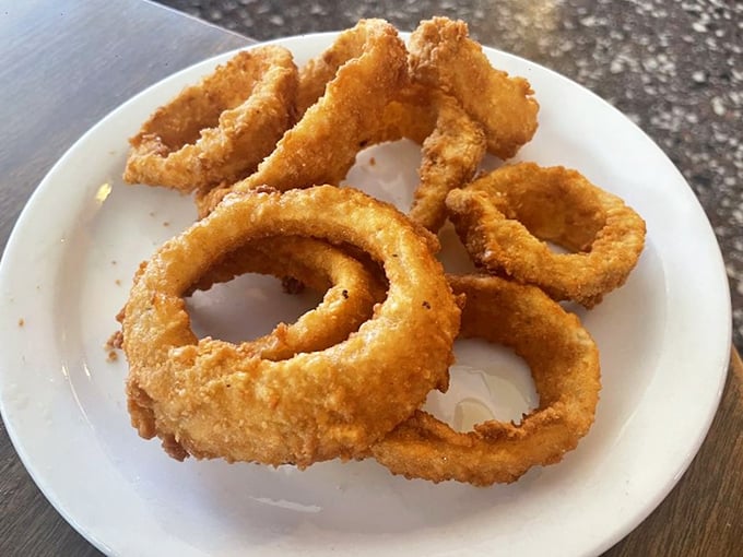 The perfect onion ring doesn't apologize for being simple—it celebrates the humble onion by wrapping it in a golden crust that shatters with each blissful bite.