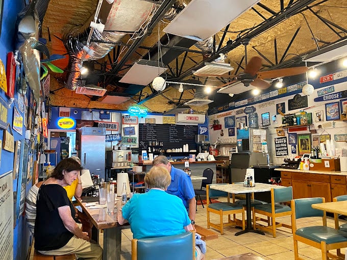 Simple tables, blue walls, and enough nautical décor to outfit a small navy. This is where seafood dreams come true without any fancy pretense.
